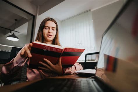 Young Businesswoman In Modern Office Analyzing Data From A Book Stock Image Image Of