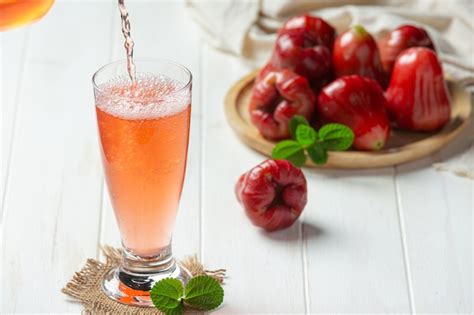 Premium Photo Rose Apple Juice On White Wooden Surface
