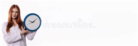 A Woman Holding A Round Clock In A Clean And Minimalist Setting With A