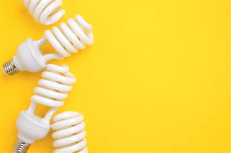 Premium Photo Fluorescent Lightbulbs On A Yellow Background Energy