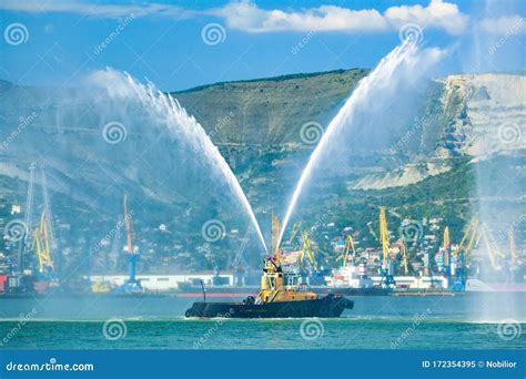 Tug Boat Is Spraying Jets Of Water Demonstrating Firefighting Water