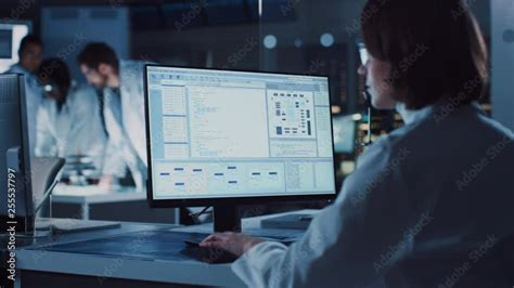 Over The Shoulder Shot Female It Scientist Uses Computer Showing System Monitoring And