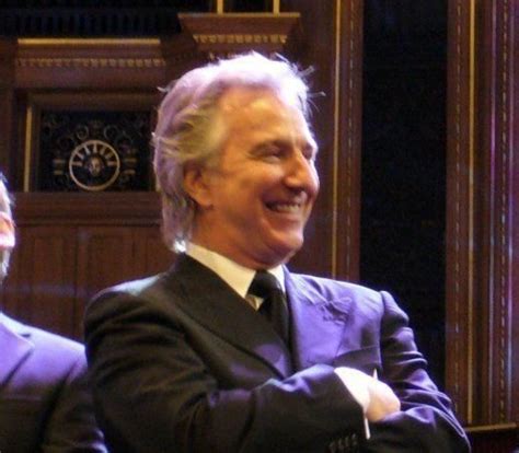 Two Men In Suits And Ties Standing Next To Each Other With Their Arms