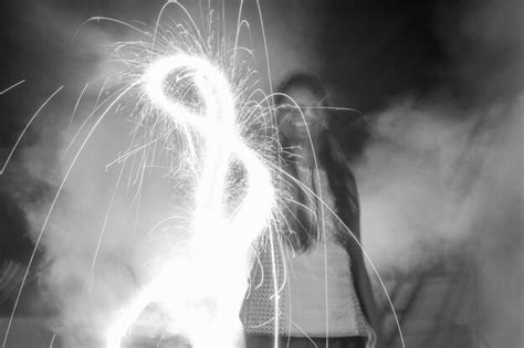 Premium Photo Woman Making Infinity Symbol With Fireworks During