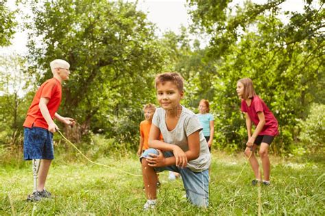 Smiling Girl Kneeling On Grass At Park Stock Image Image Of Happiness