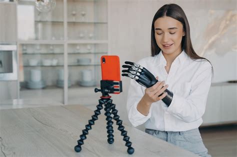 Premium Photo Joyful Woman With A Bionic Arm Filming A Vlog Showcasing The Seamless Blend Of
