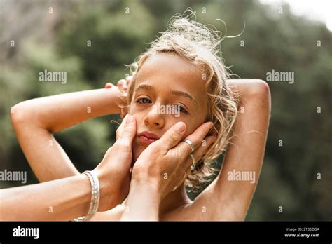 Hands Of Mother Touching Son S Face Stock Photo Alamy