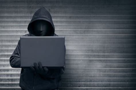 Hacker In Black Hoodie Holding Laptop With Virtual Display Server Data