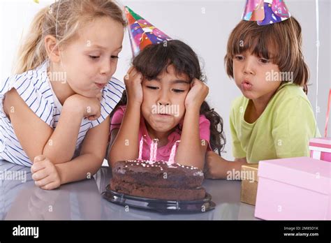 Make A Birthday Wish A Young Girl Blowing Out Her Birthday Candles As