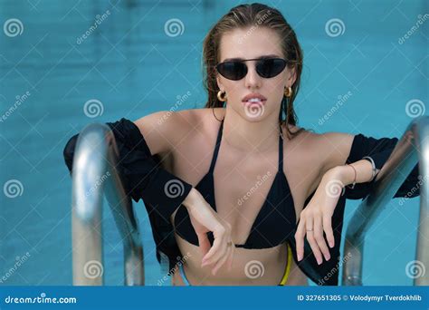 Beautiful Young Woman Model In Bikini In Swimming Pool Posing In