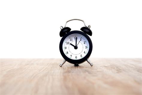 Premium Photo Selective Focus Of Black Table Clock On Wood Table