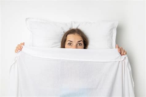 Premium Photo Surprised Young Woman Covering Herself With A White