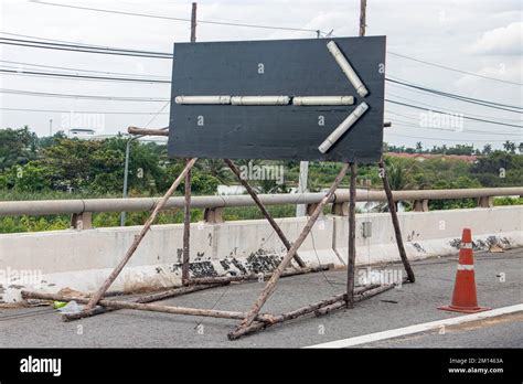 The Direction Indicator With Neon Lights On A Wooden Structure Stock