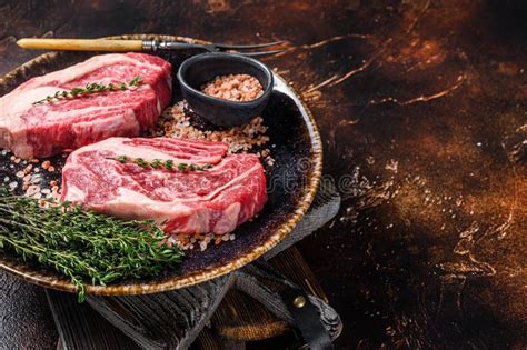 Chuck Eye Roll Beef Steaks Raw Meat On A Plate With Thyme And Herbs