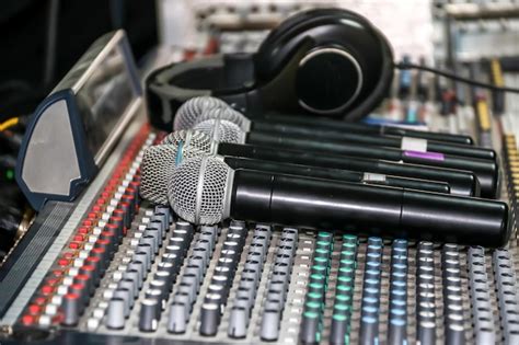 Premium Photo Wireless Microphone And Headphone On Sound Music Mixer