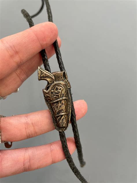 Etched Bronze Gun And Holster Pendant Black Leather Woven Cord Bolo Tie