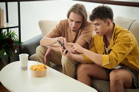 Premium Photo Men Exploring New Mobile App