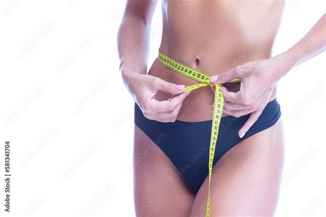 Sexy Slim Caucasian Woman Body Taking Measure Reading With Tape Measure In Hand In Front Of