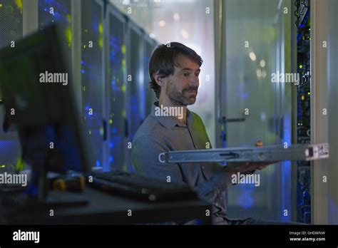 Server Room Technician Removing Rack From Cabinet Panel Stock Photo Alamy
