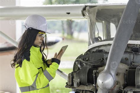 Technician Fixing The Engine Of The Airplane Female Aerospace Engineering Checking Aircraft