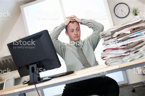 Businessman Sitting At His Desk Overwhelmed With Paperwork It S A