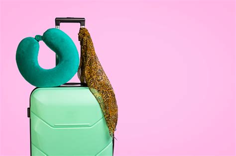 플라스틱 여행 케이스와 손잡이에 부착 된 스카프 분홍색 배경의 여행 용 베개 여행 출장 친구와 친척을 방문하는 여행의 개념 가방에 대한 스톡 사진 및 기타 이미지 Istock