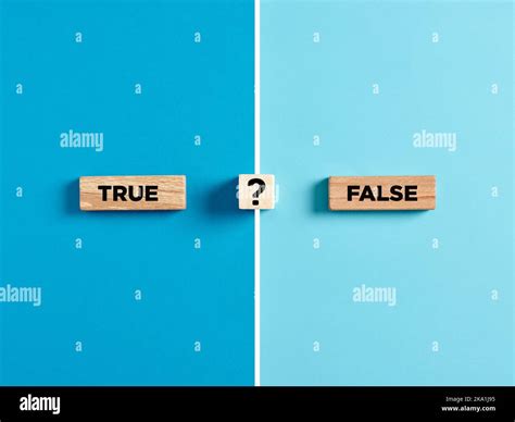 the words true and false on wooden blocks with question mark symbol dilemma or choice between