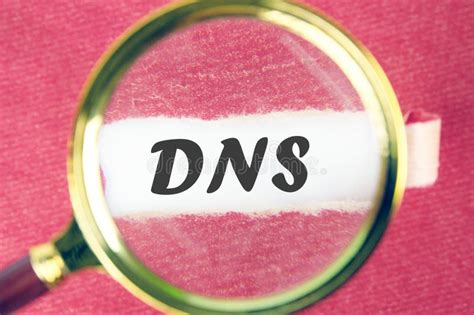 Dns Domain Name System Word Through A Magnifying Glass Under A Torn