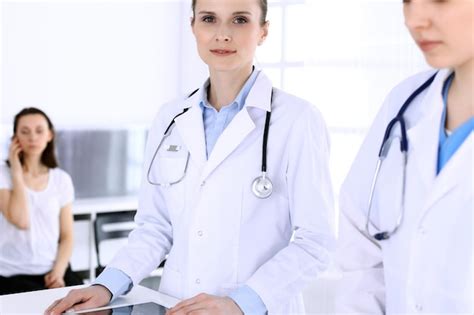 Premium Photo Group Of Doctors At Work In Hospital With Patient In A