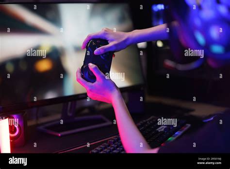 Female Cyber Hacker Gamer Use Joystick To Competition And Playing Games On Computer In Neon
