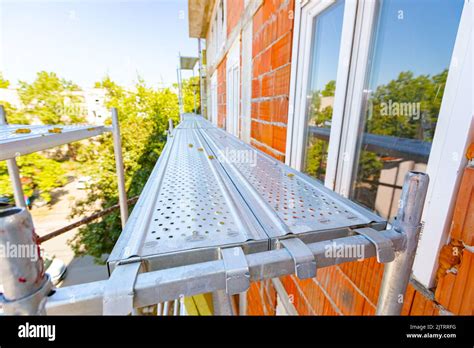 Place Of Metal Perforated Scaffold For Trampling Installed Against