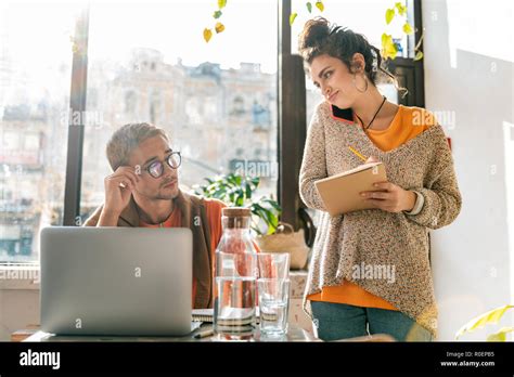 Dark Haired Wife Calling Business Partner Standing Near Her Husband