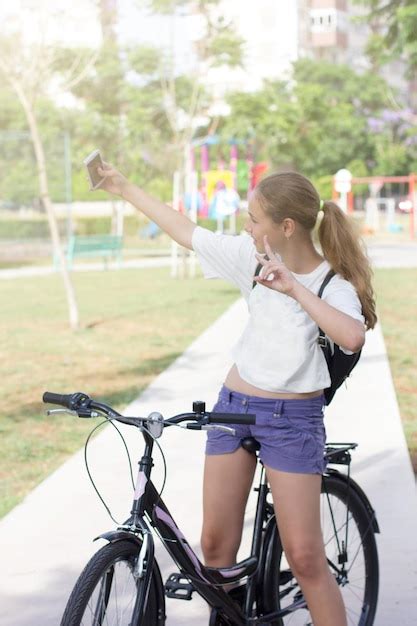 Premium Photo Young Girl Riding Bicycle On Park