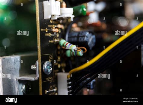 A Close Up Portrait Of Some Resistors On A Black Circuit Board In An Open Electronic Device On
