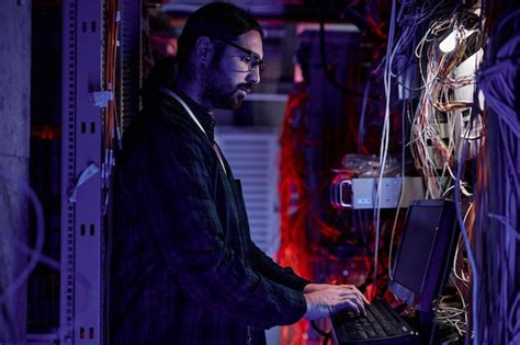 Premium Photo Bearded System Administrator Setting Up Server Network