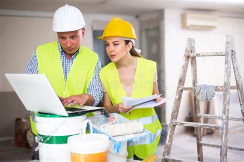 Woman Architect And Man Engineer Discussing Reconstruction Project