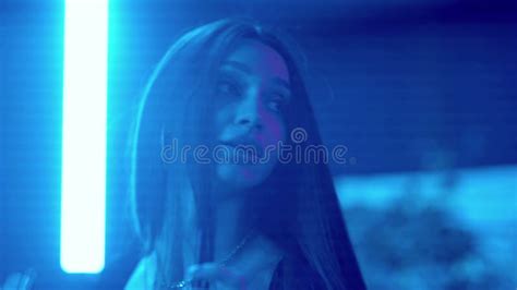 Close Up Of A Girl In A Club Dancing And Drinking Alcohol Under A Neon