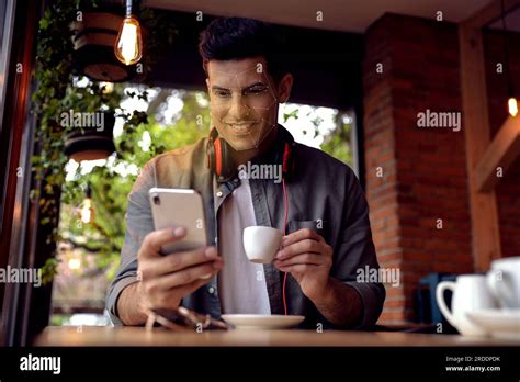 Man Using Smartphone With Facial Recognition System In Cafe Security Application Scanning His