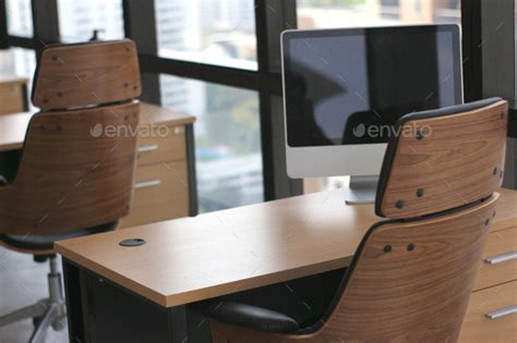 Wooden Table Desk In Office Business Room With Big Computer Monitor And