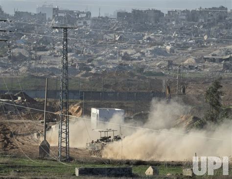 Photo Israeli Apcs Churn Up Dust As It Enters The Gaza Strip