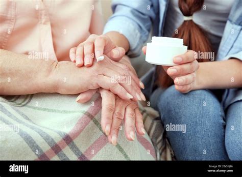 Granddaughter Helping Granny To Apply Skin Cream Close Up Stock Photo Alamy