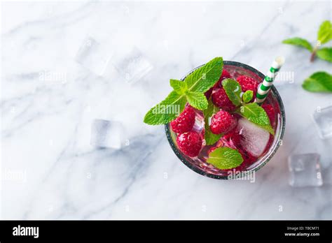 Raspberry Cocktail Fizz Lemonade Ice Tea With Fresh Mint On Marble