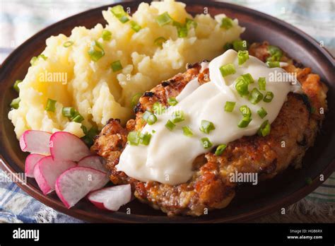 Chicken Fried Steak And White Gravy With Mashed Potatoes On A Plate