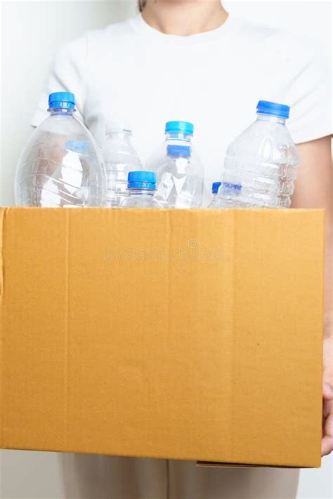 Volunteer Keep Plastic Bottle Into Paper Box At Home Or Office Hand