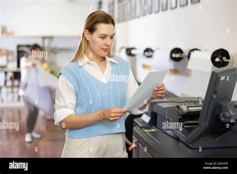 Woman Checking Paper After Printing Stock Photo Alamy