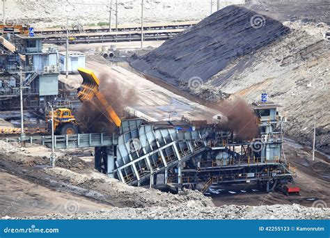 Heavy Construction Tipper Trucks Dump Coal To The Conveyor Stock Image