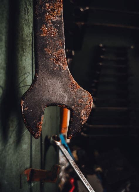 Old Rusty Wrench Spanner Tool Hanging In Abandoned Workshop Stock