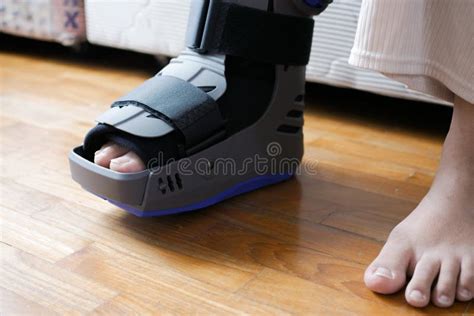 Women Broken Feet With A Grey Plastic Boot Ankle Brace Injury