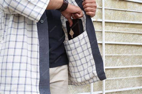 Premium Photo Photo Of Man Pull Out Something From His Pocket