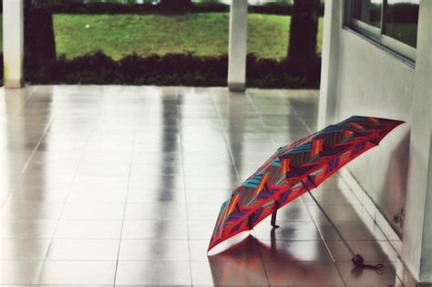 Premium Photo Umbrella On Tiled Floor By Wall